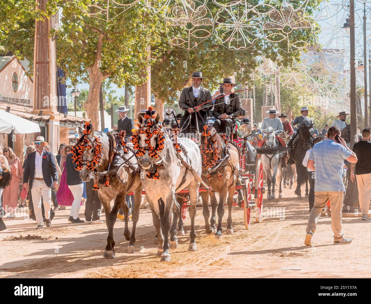 Group of Spanish riders in traditional attire on horseback at an ...