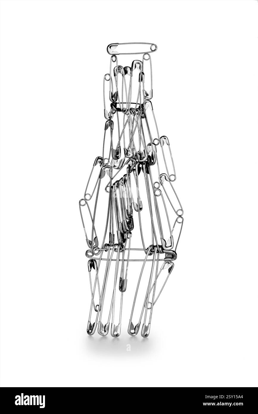 Balancing of safety pin, india, asia Stock Photo - Alamy