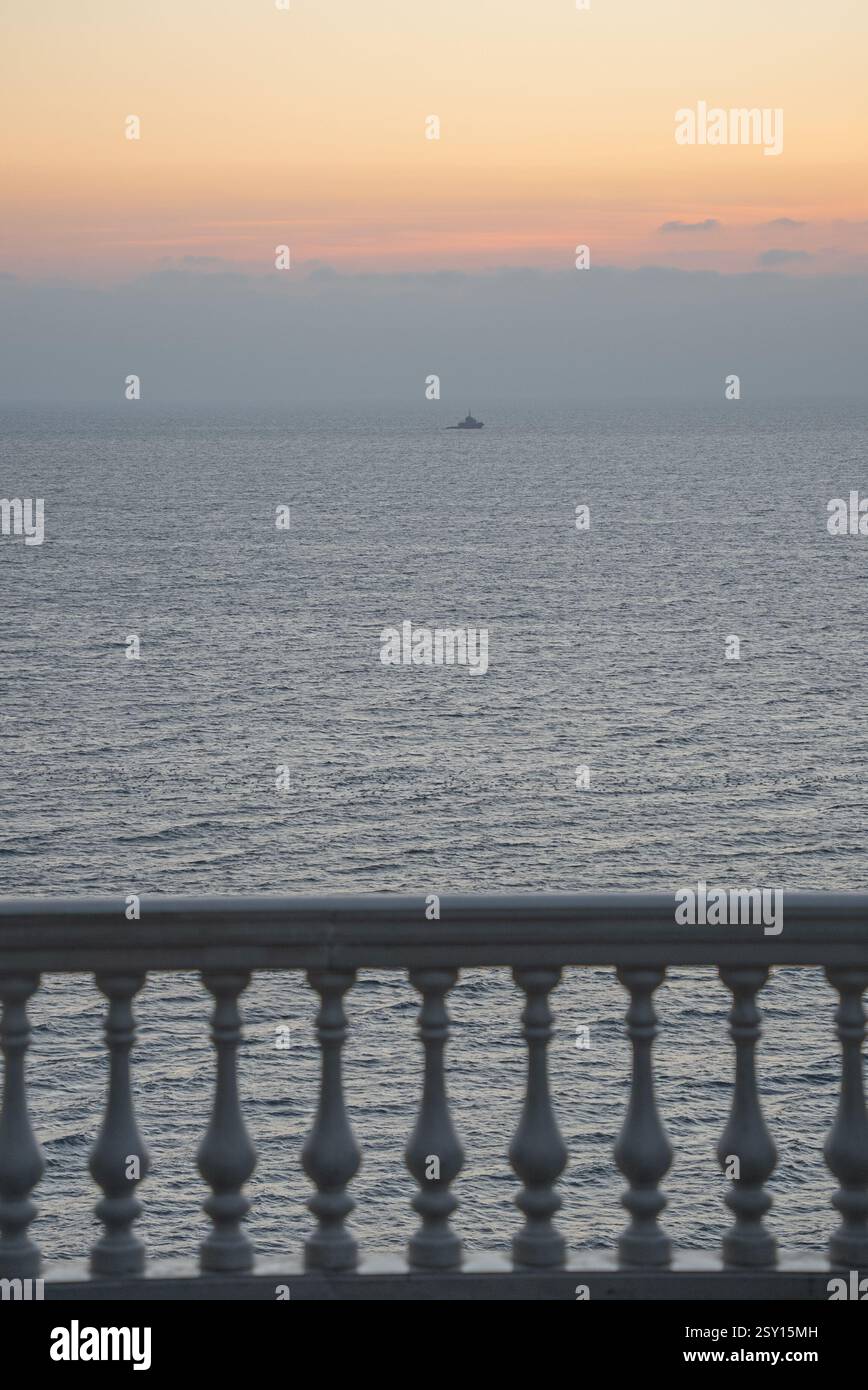 White cement railing in classical roman style, Black Sea, boat and ...