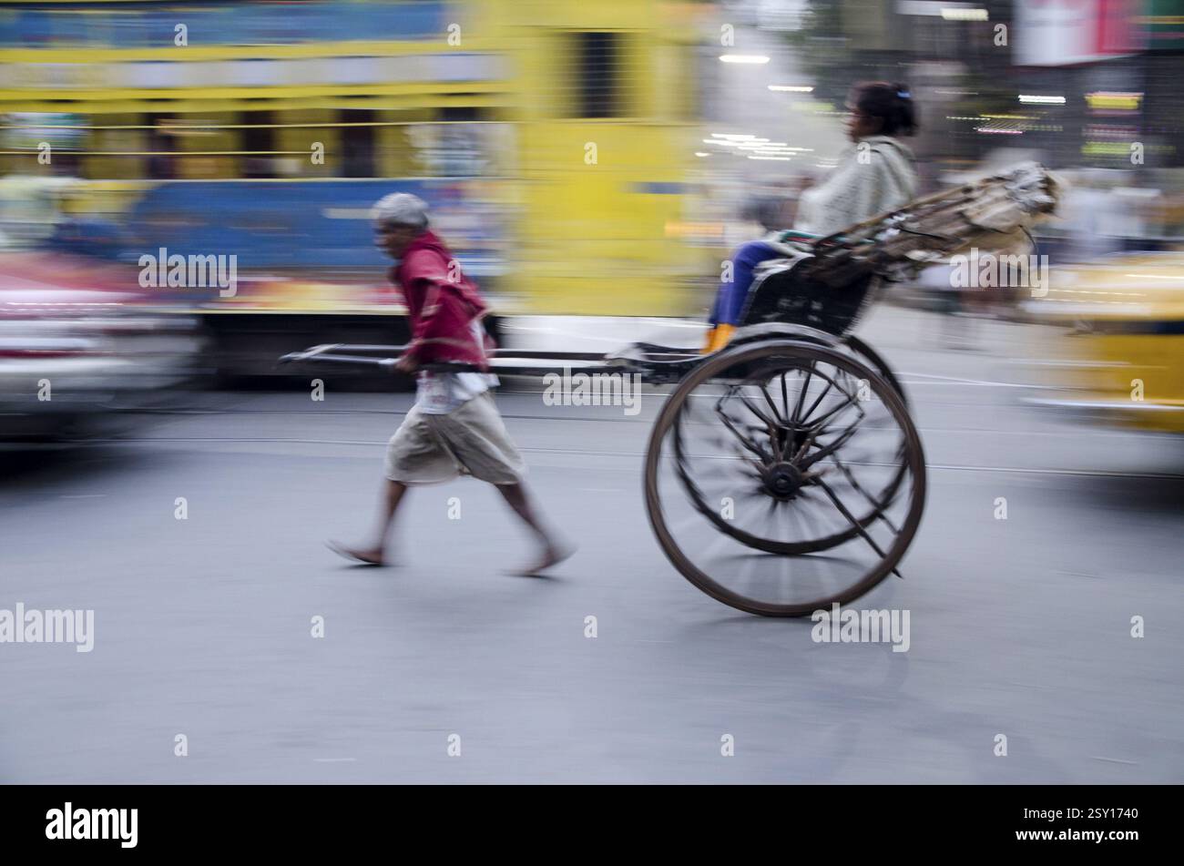 Man pulling hand rickshaw on road Kolkata West Bengal India Asia Stock ...