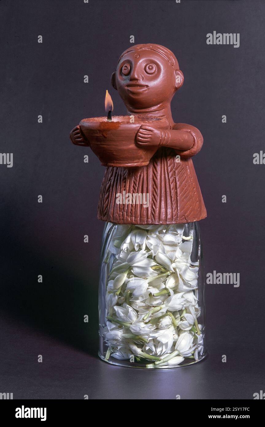Terracotta woman statue holding diya diwali festival, India, Asia Stock ...