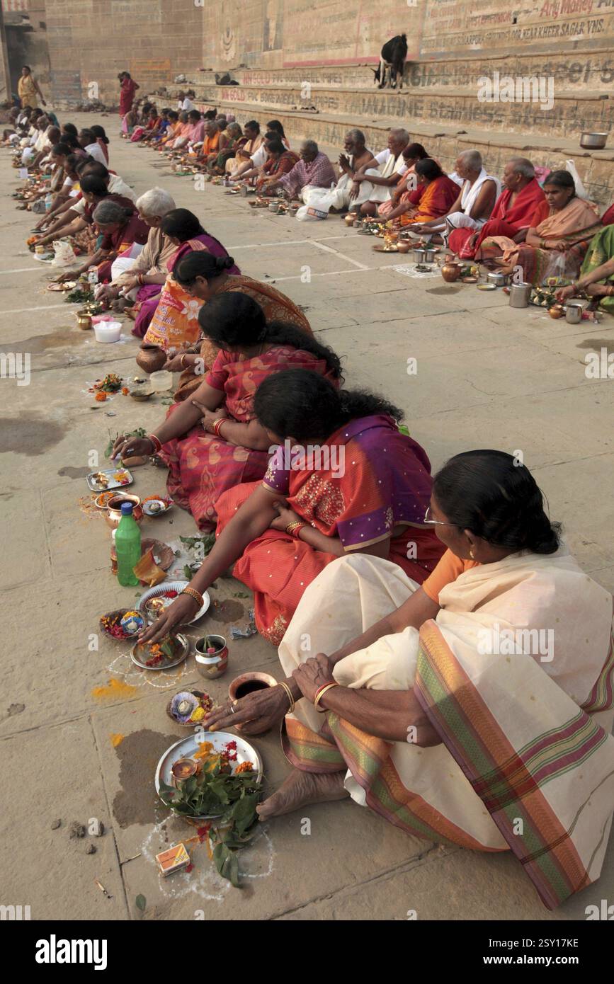Devotees eating food after religious ritual Ganga River ghat at ...