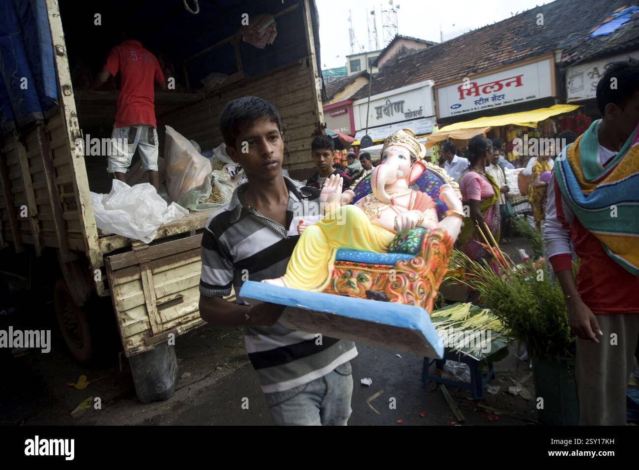 Boy holding Ganesha sculpture in Dadar market Mumbai Maharashtra India ...