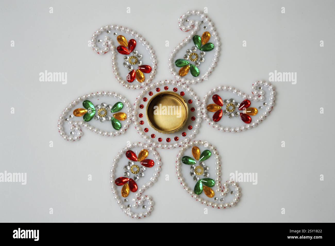 Mango Shape Rangoli Made of Pearls on White Background Stock Photo - Alamy