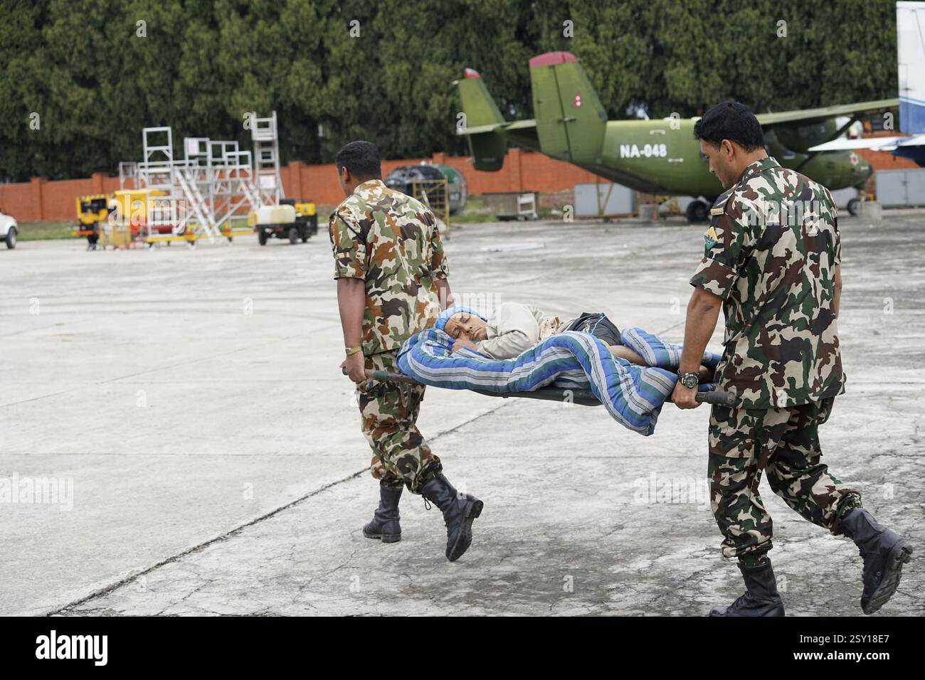 Army personnel carry injured person stretcher, earthquake, nepal, asia ...