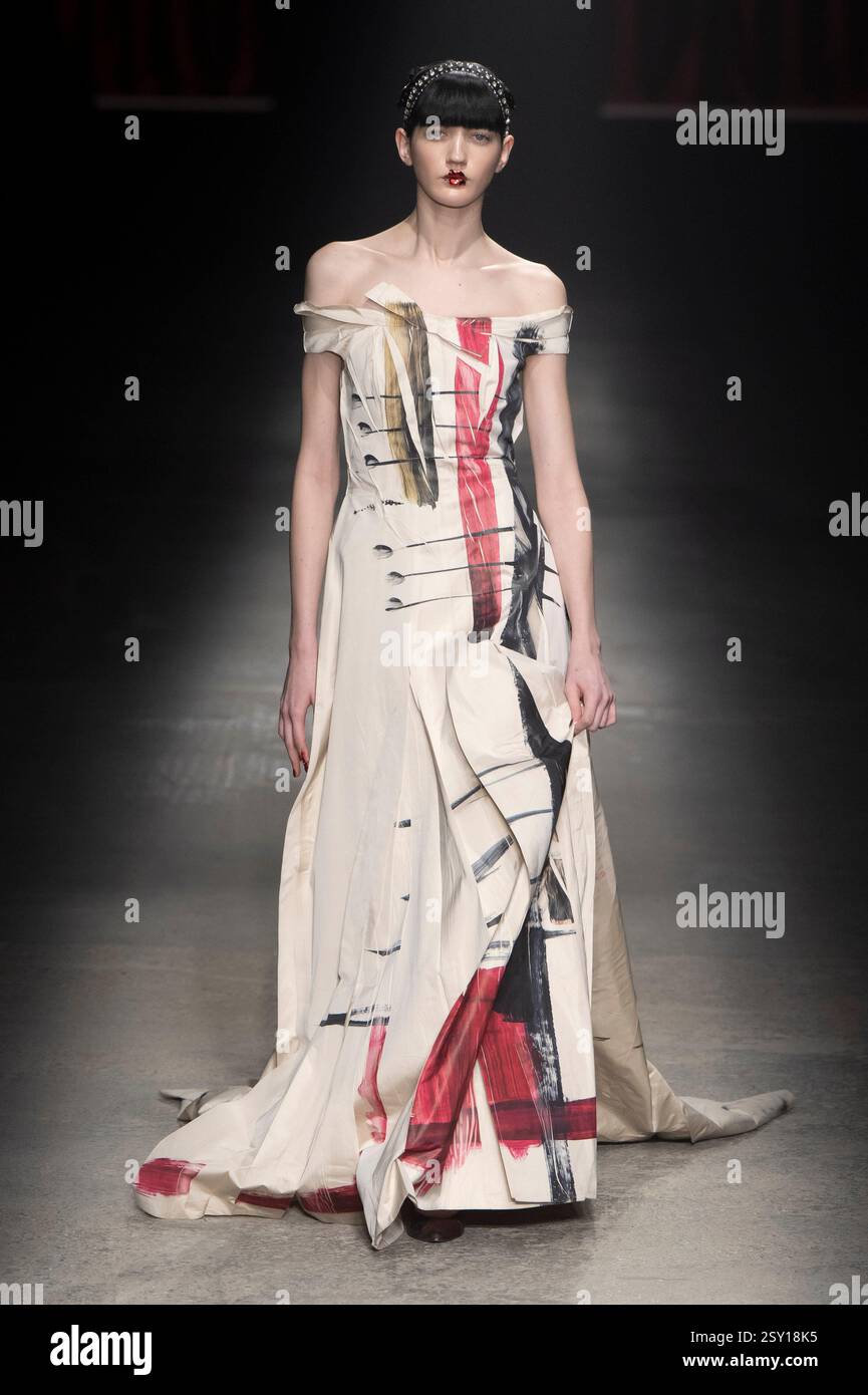 Milan, Italy. 26th Feb, 2025. A model walks on the runway during the ...