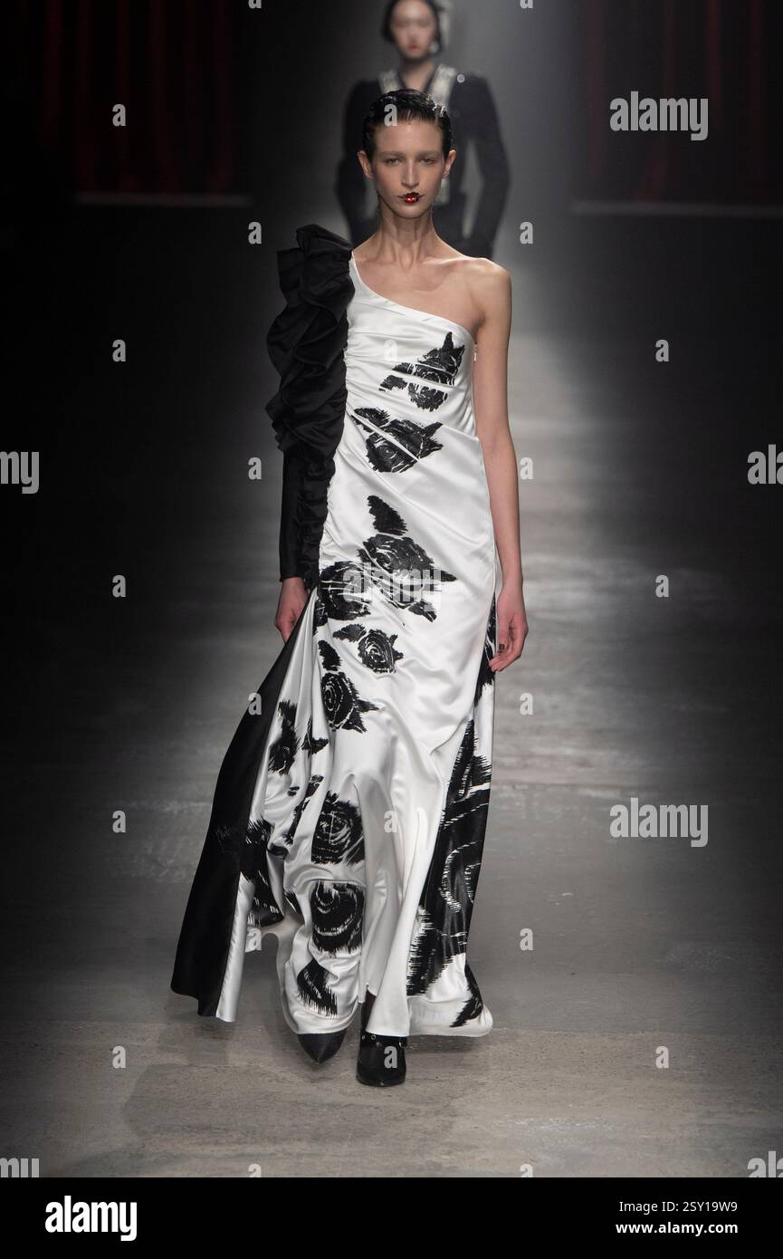 Milan, Italy. 26th Feb, 2025. A model walks on the runway during the ...