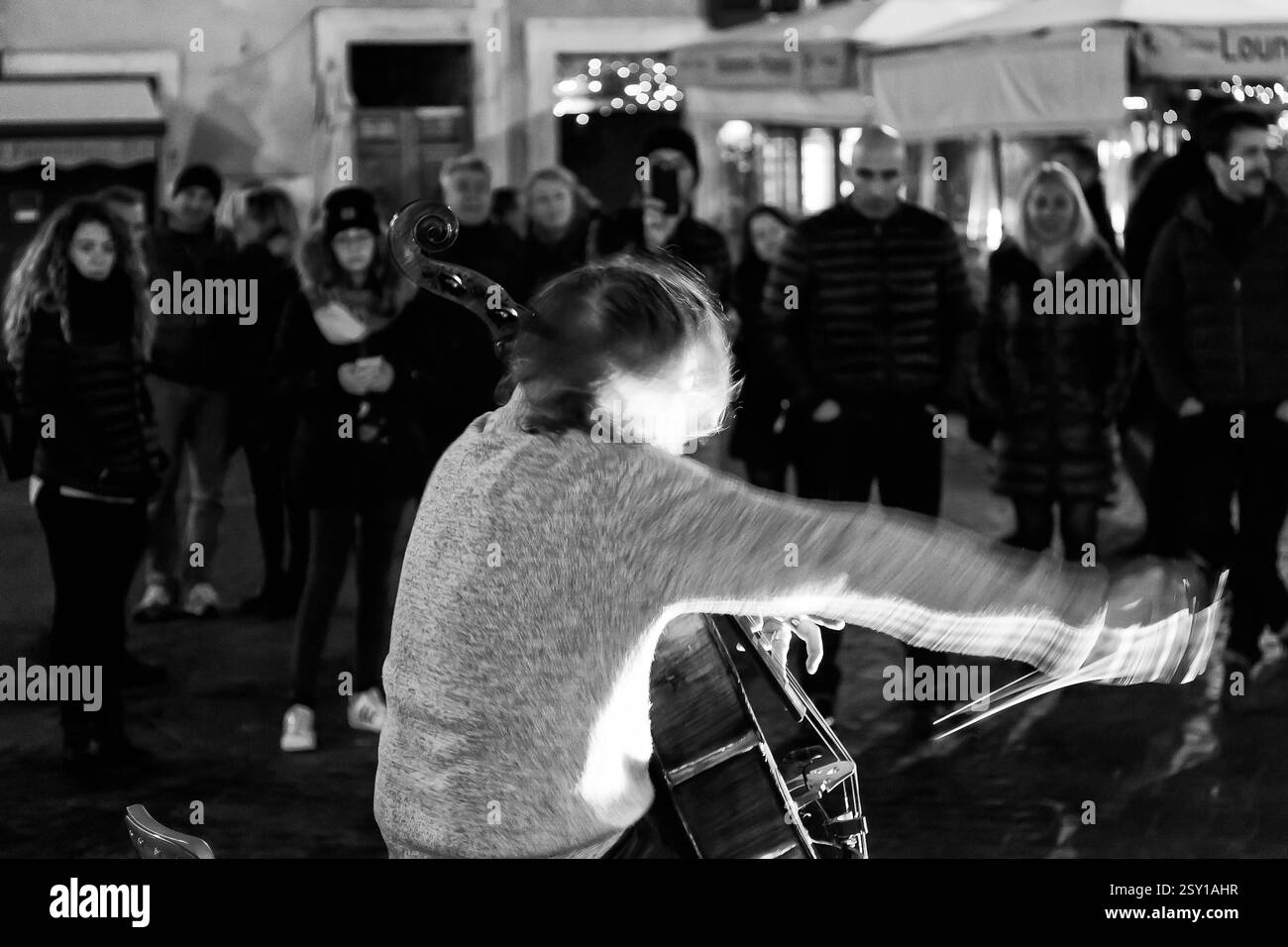 Street musician Street musician performs, for a small group of people ...