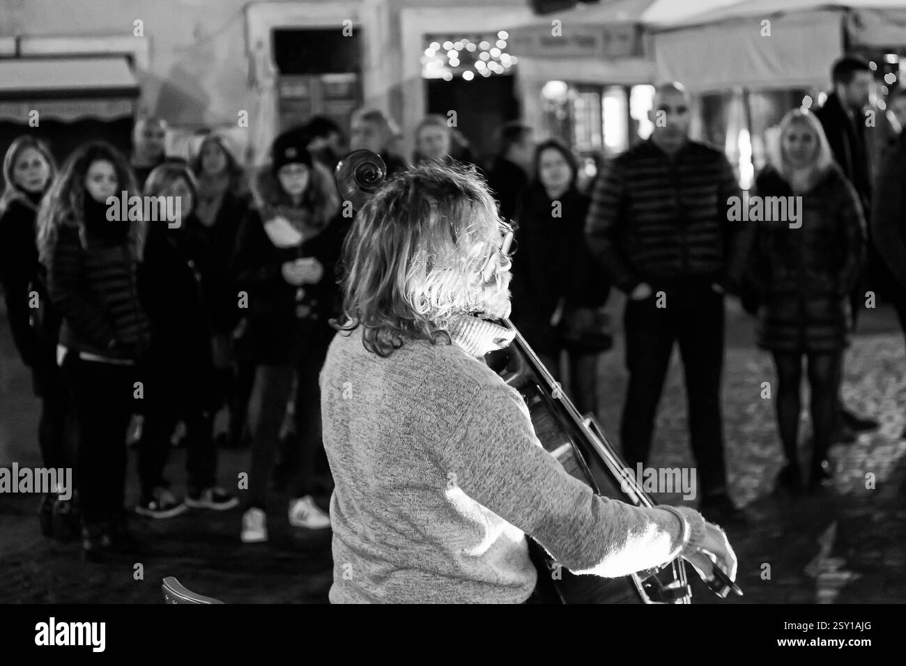 Street musician Street musician performs, for a small group of people ...