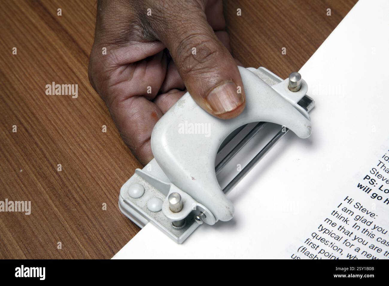 Man punching paper MR#743AD Stock Photo - Alamy