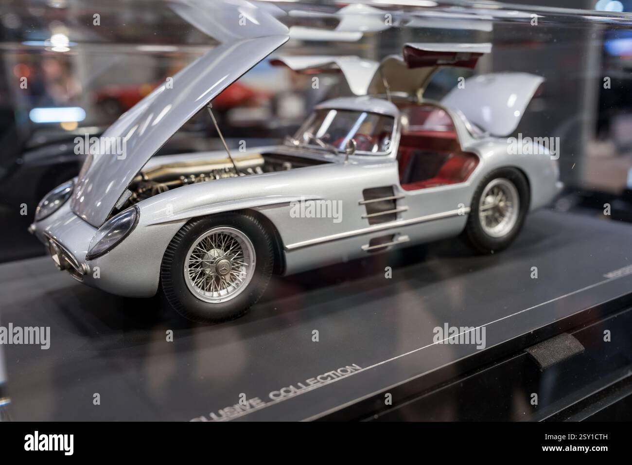 Stunning silver sports car showcased in a glass display highlighting ...