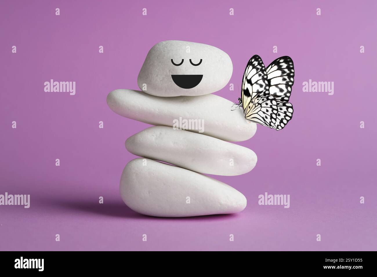 Happy stone glad to see butterfly, harmony. Stacked pebbles and one ...