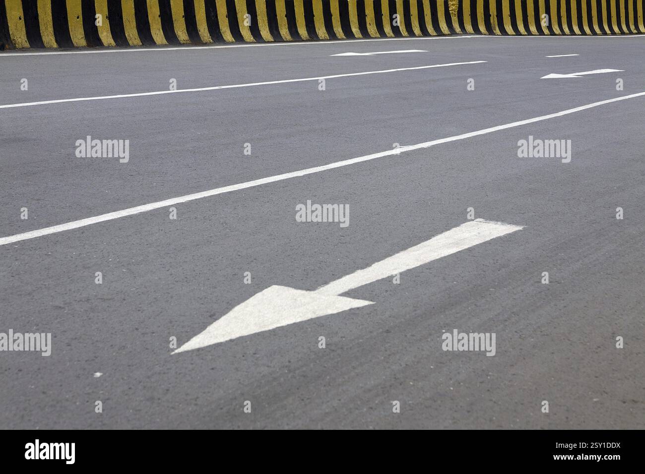 Arrow traffic sign on the road and Divider Mumbai Maharashtra India ...