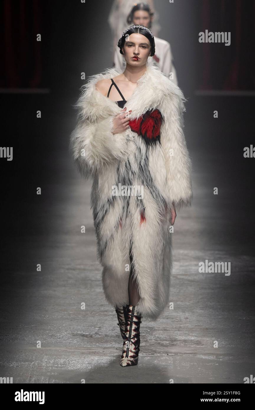 Milan, Italy. 26th Feb, 2025. A model walks on the runway during the ...