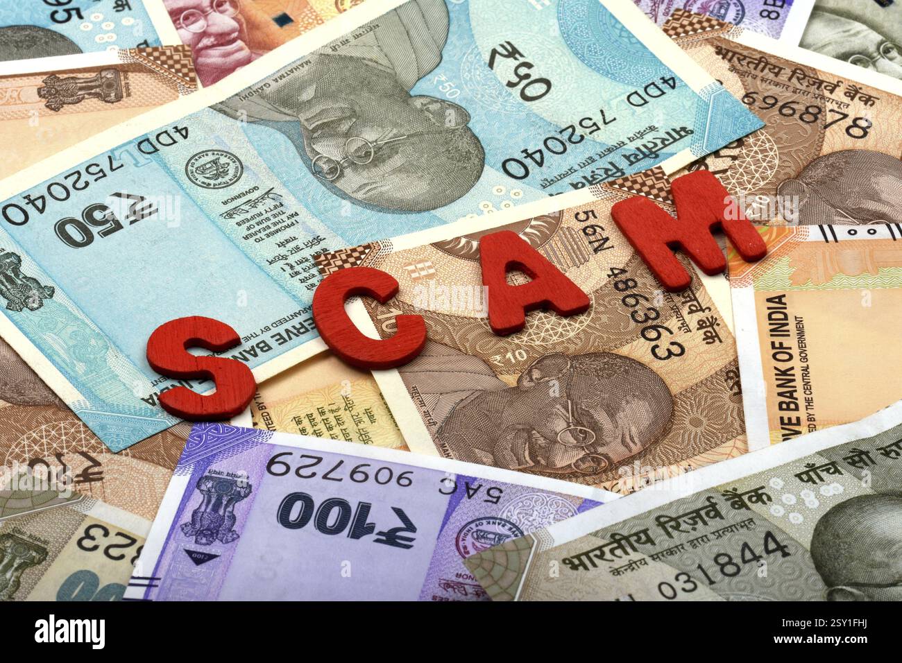 Scam and money concept, Scam red alphabets on money background, Indian ...