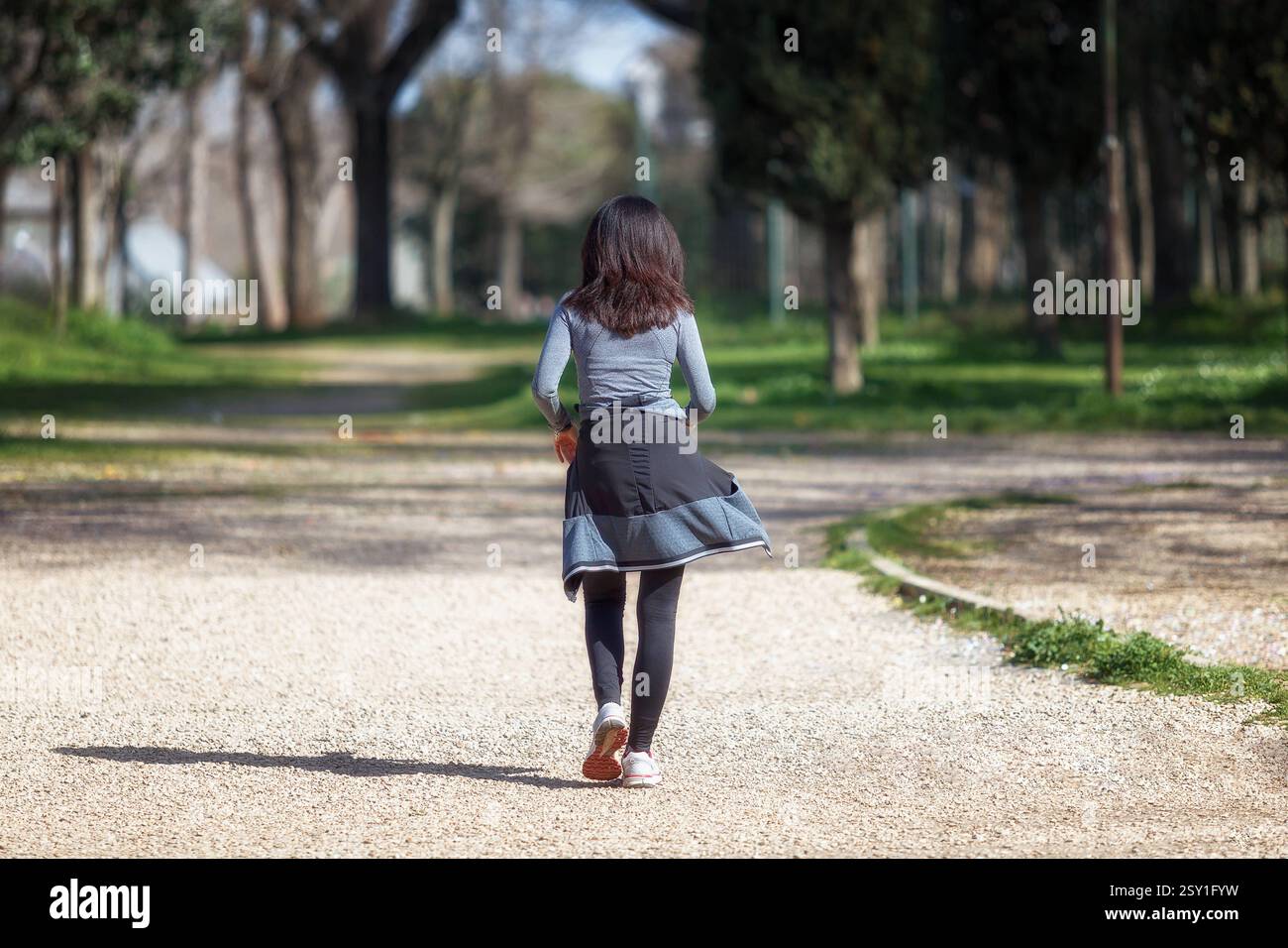 girl runs to the park Rome, Italy - February 26, 2017: Woman in ...