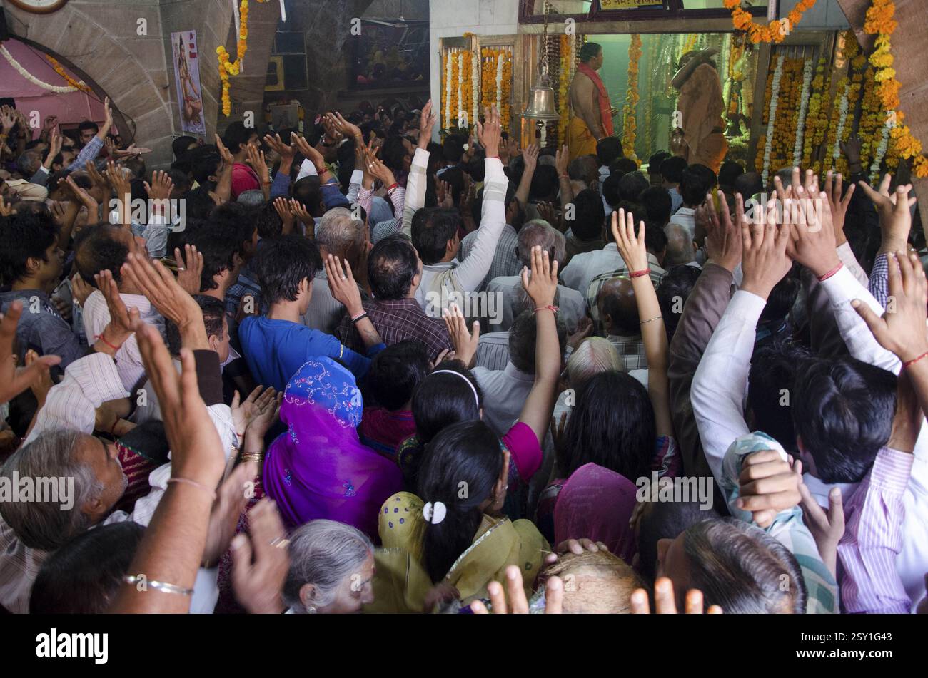 People raising hands in aarti temple, jodhpur, rajasthan, india, asia ...