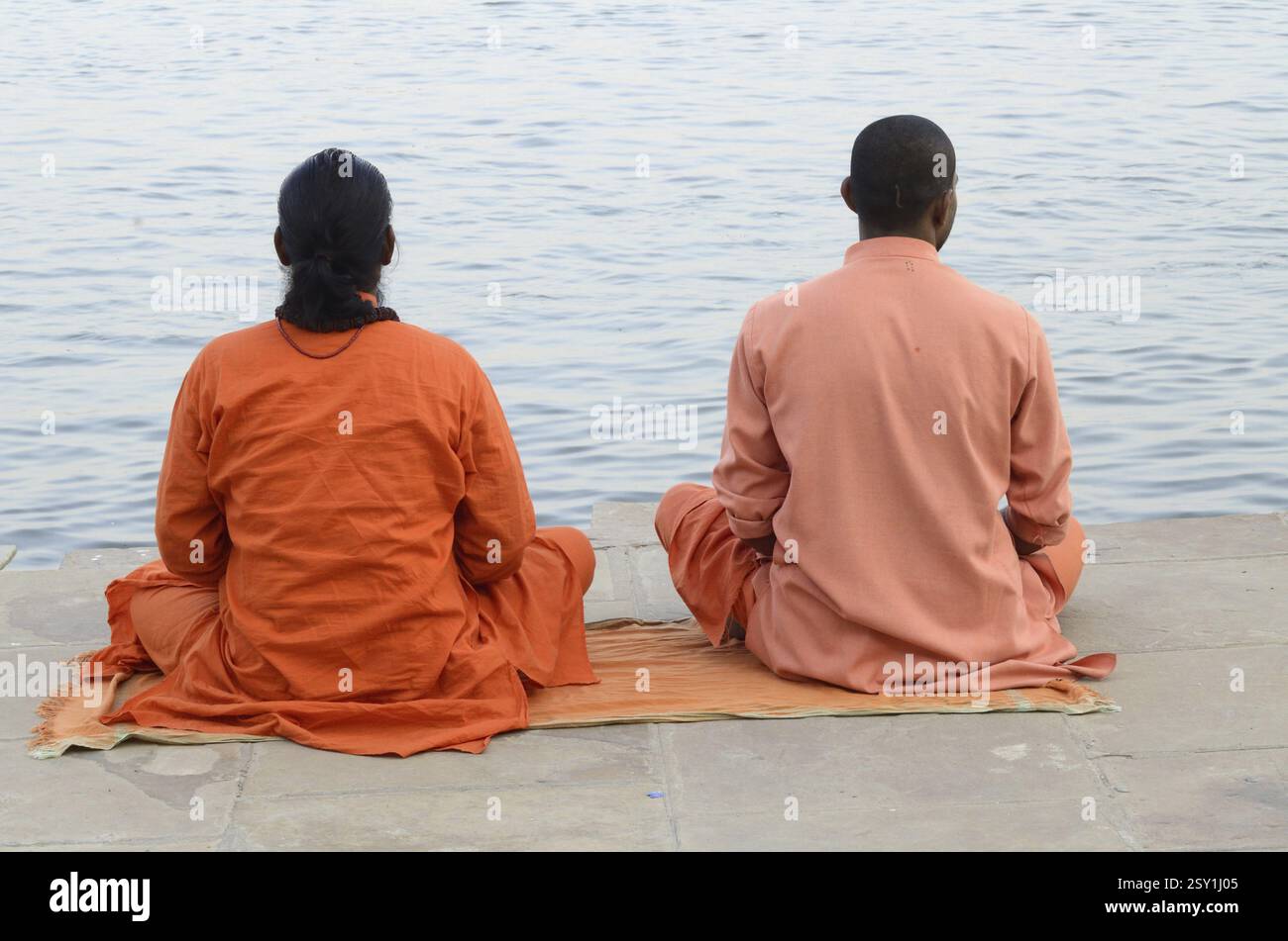 Priest sitting meditation position in Ganga river on Varanasi ghat ...