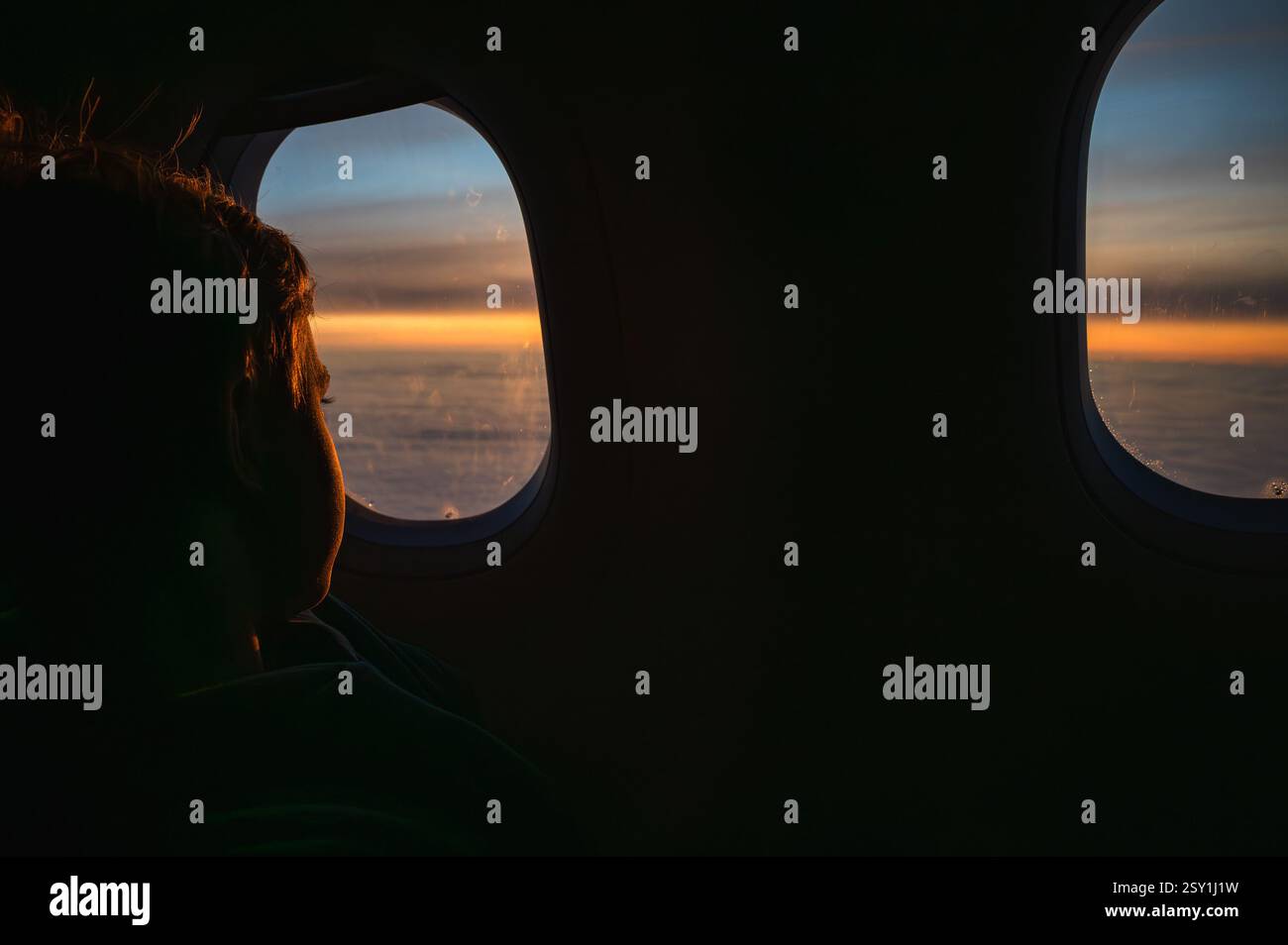 Boy looking throw the window in the flying airplane Stock Photo - Alamy