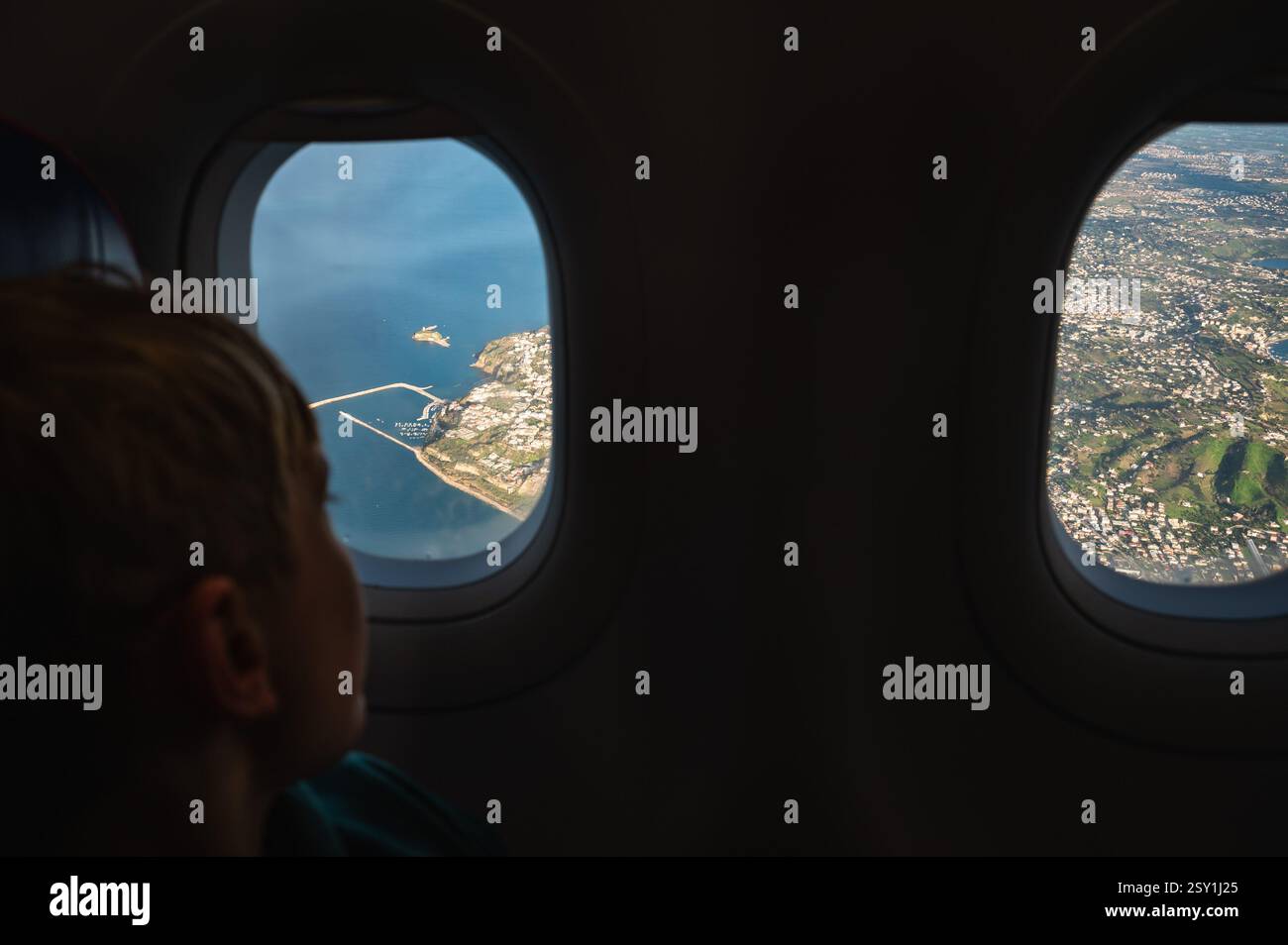 Boy looking throw the window in the flying airplane Stock Photo - Alamy