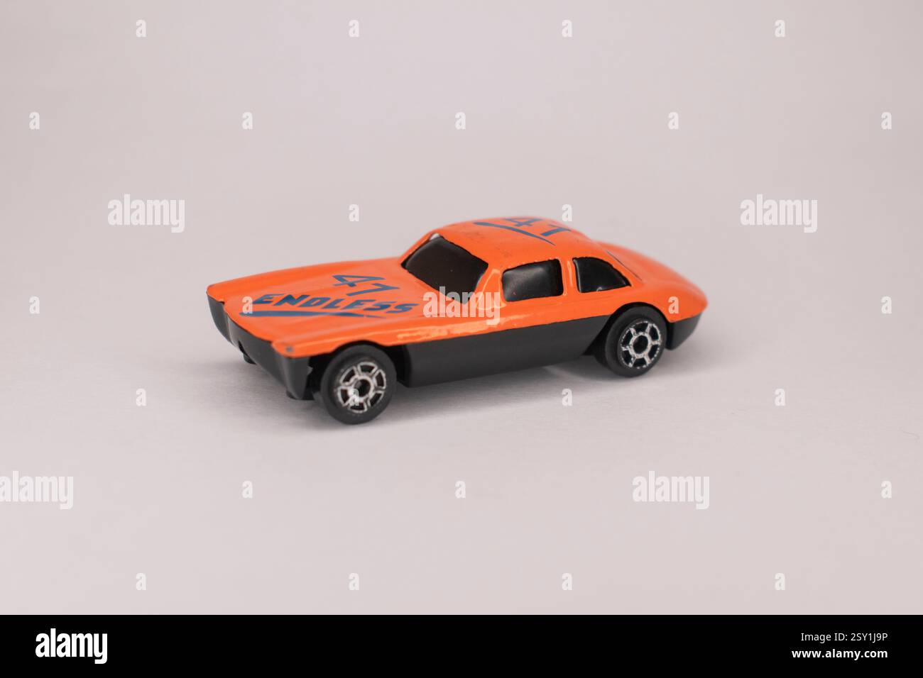 Hot Wheels orange car model isolated on white background with copy ...