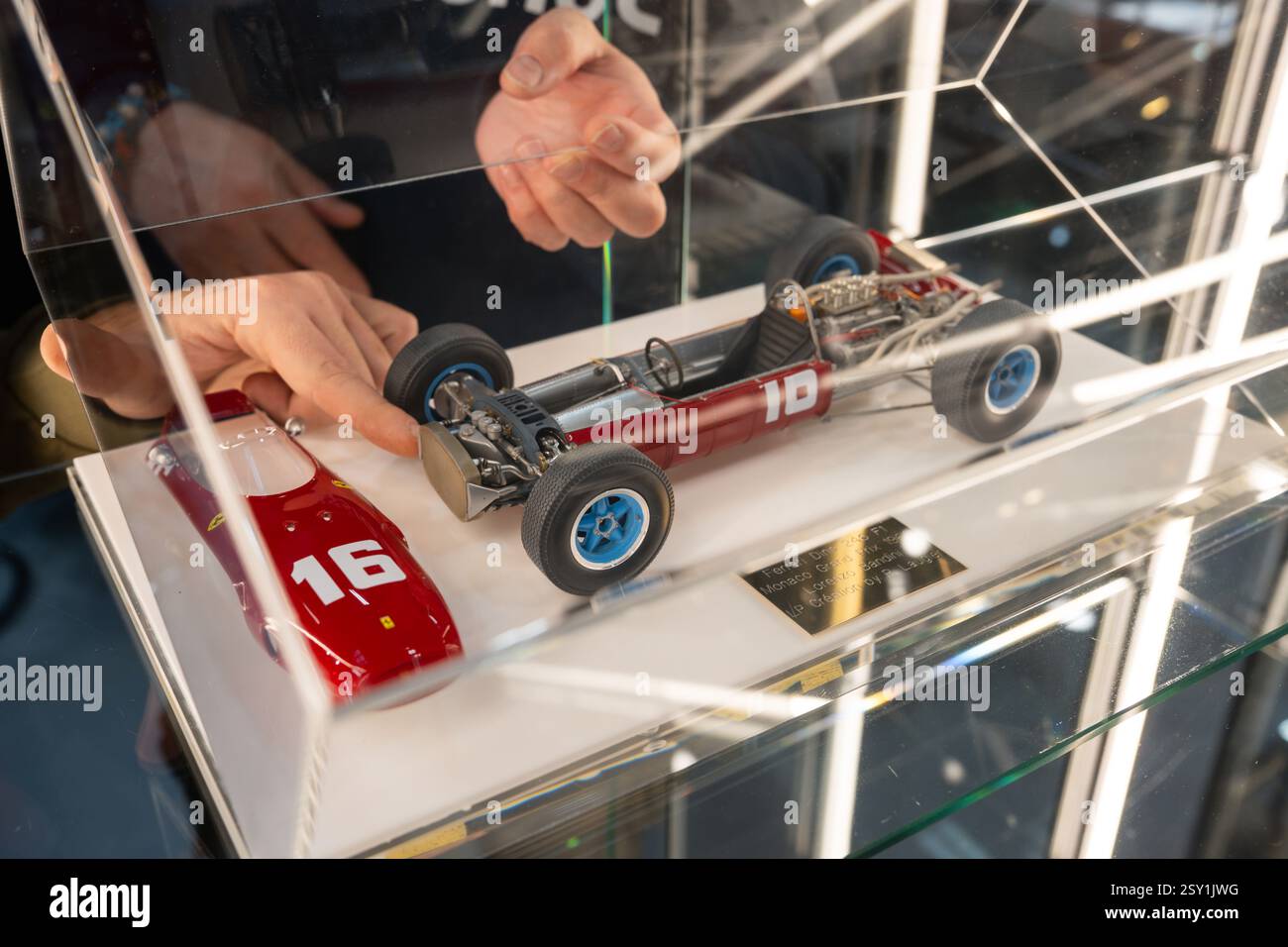 Intricately crafted model race car displayed in a glass case showcasing ...