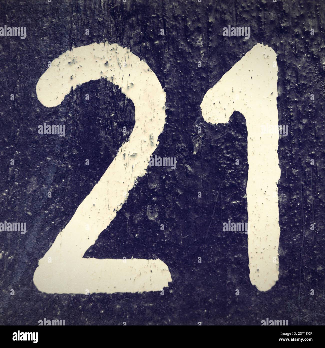 Number 21. White number on a dark background. Black and white old photo ...