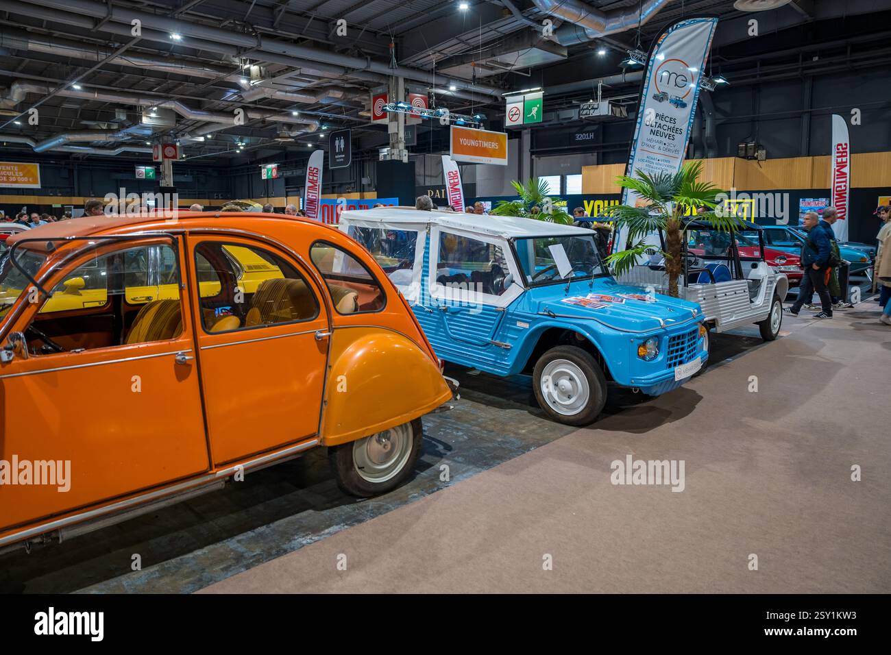 Vintage car enthusiasts gather at a lively auto exhibition in vibrant ...