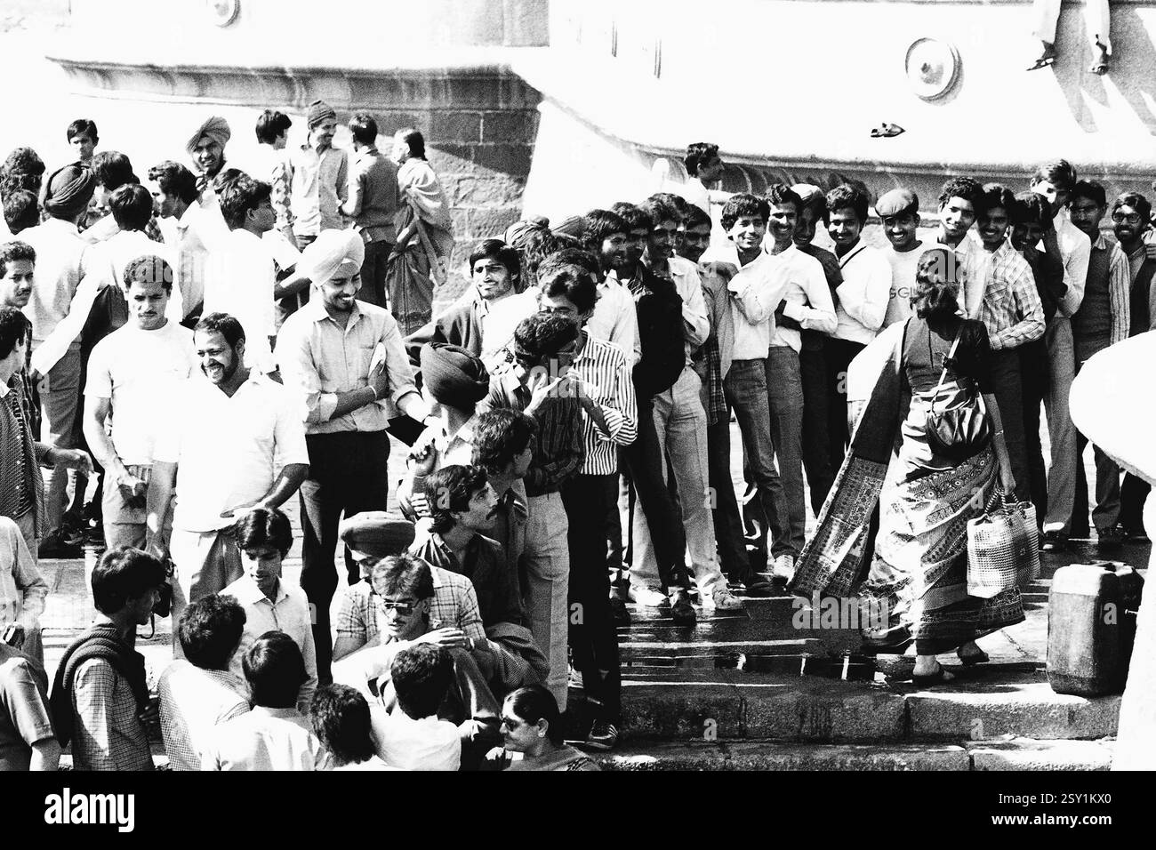 Men in queue looking smiling at women Gateway of India Mumbai India ...