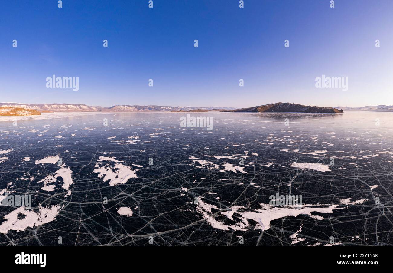 Aerial view on transparent frozen water, violet sunset in background ...