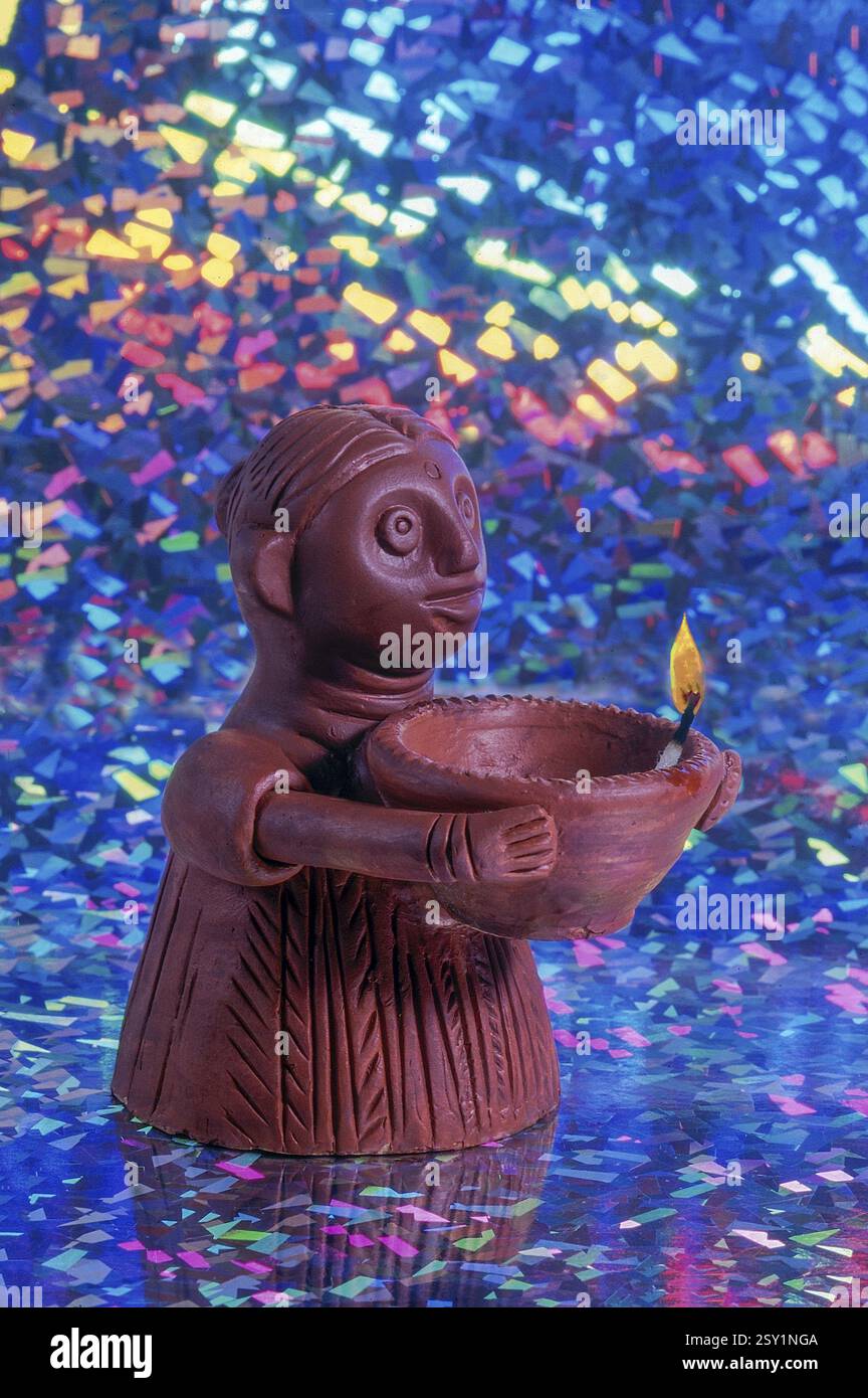 Terracotta woman statue holding diya diwali festival, India, Asia Stock ...