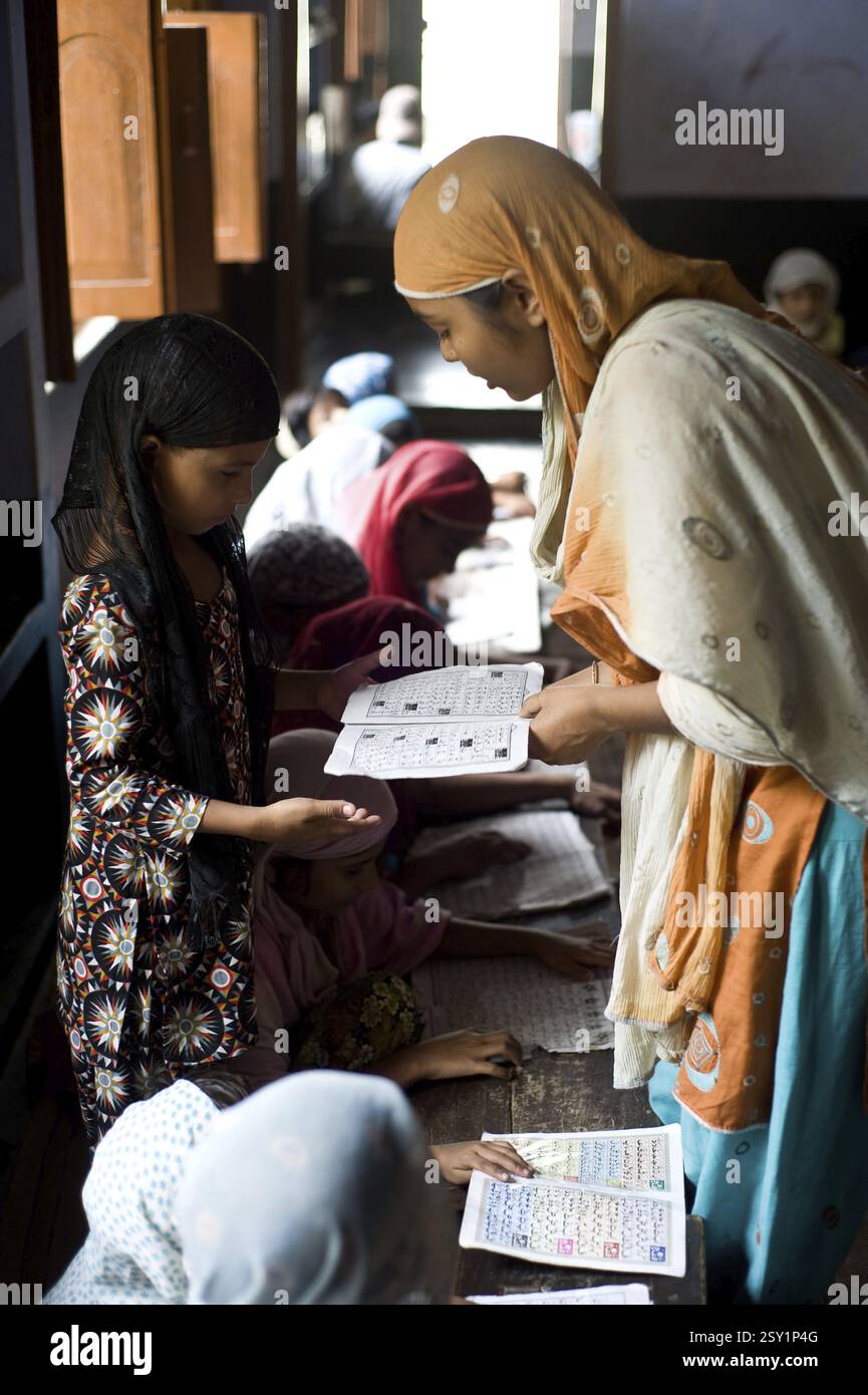 Muslim teacher with children in classroom at Islamic school uttar ...