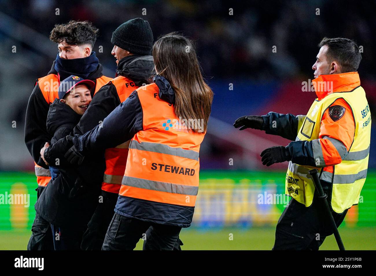 Barcelona, Spain. 25th Feb, 2025. Child fan jumps onto the field during ...