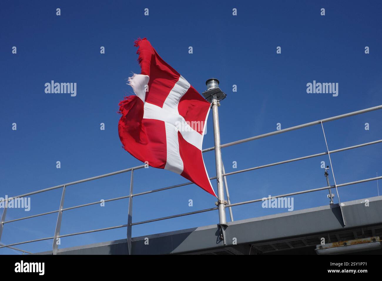 A fluttering Danish flag in a strong wind. The flag is starting to fray ...