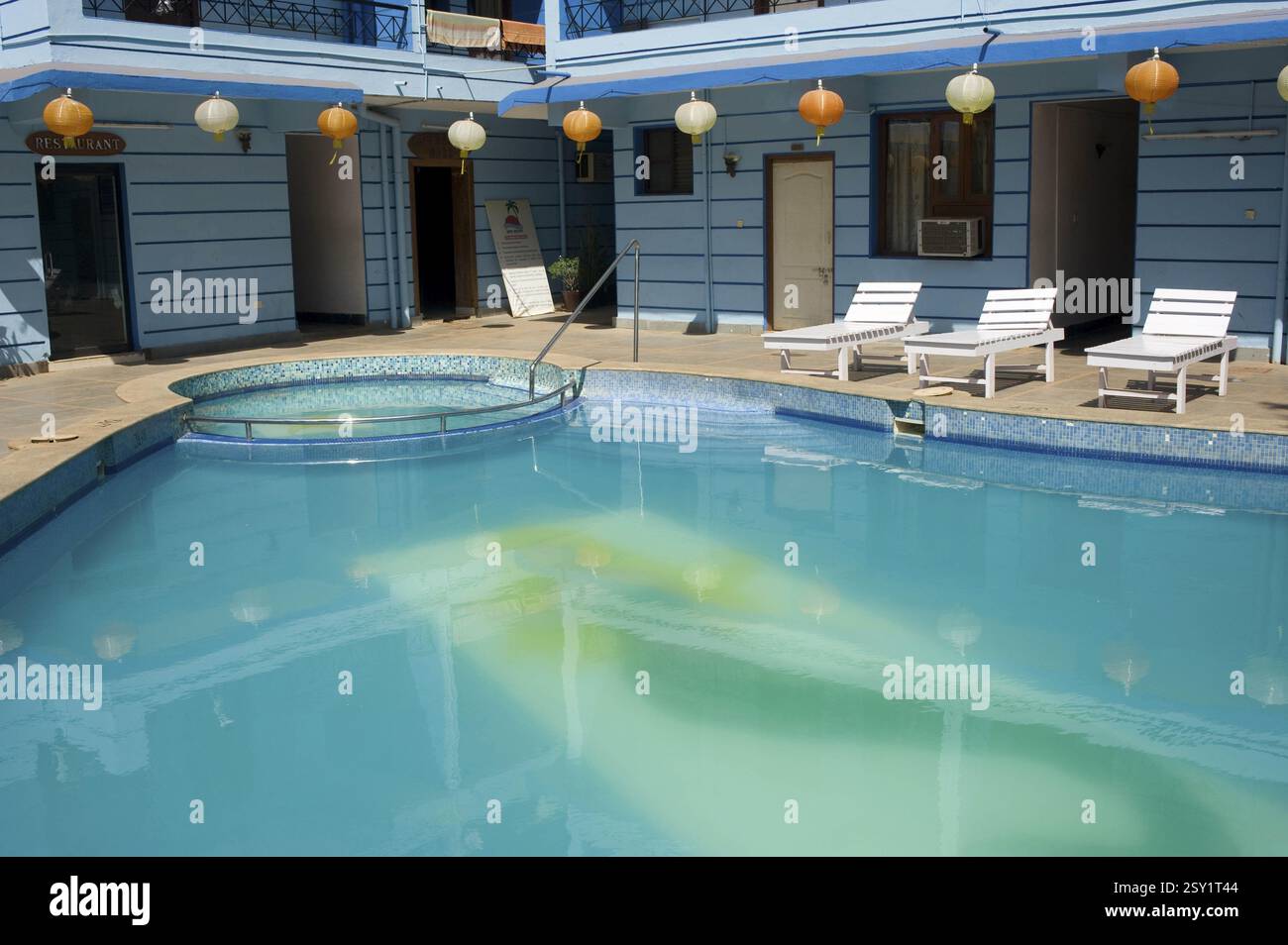 Swimming pool and wooden beds in resort calangute, goa, india, asia ...