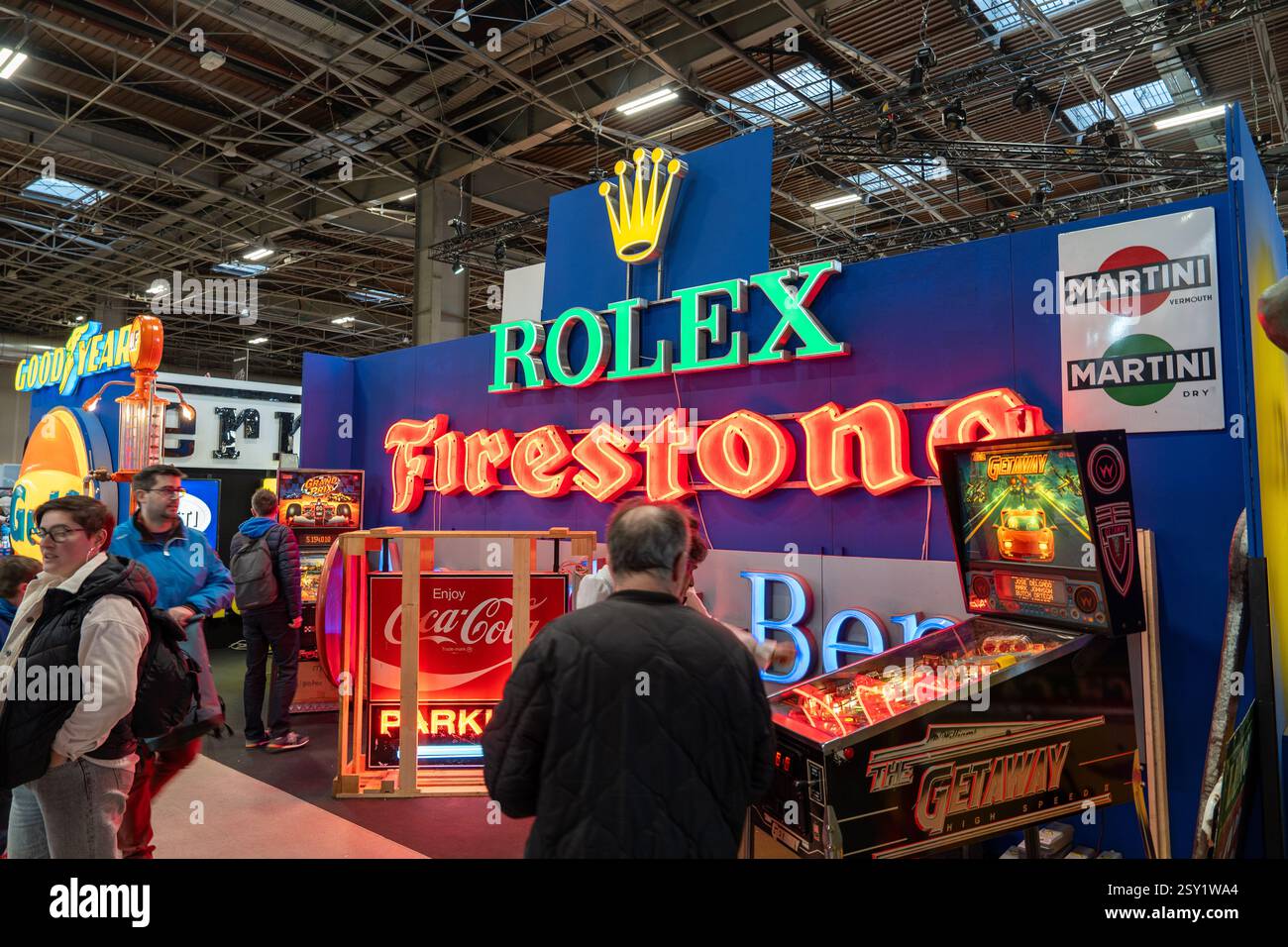 Bright neon lights illuminate a bustling arcade filled with vintage ...