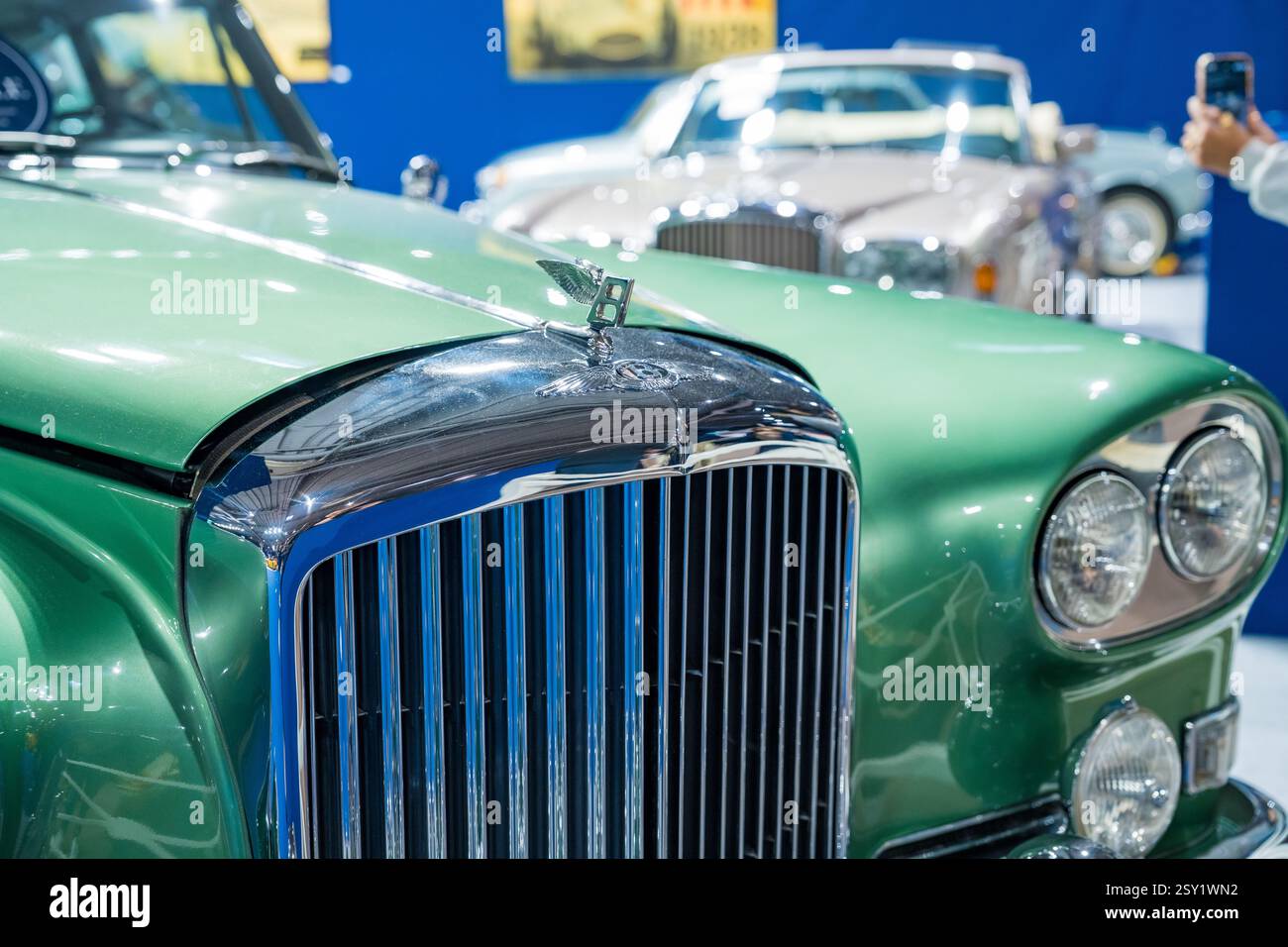 Classic luxury cars on display in a vibrant showroom with stunning ...