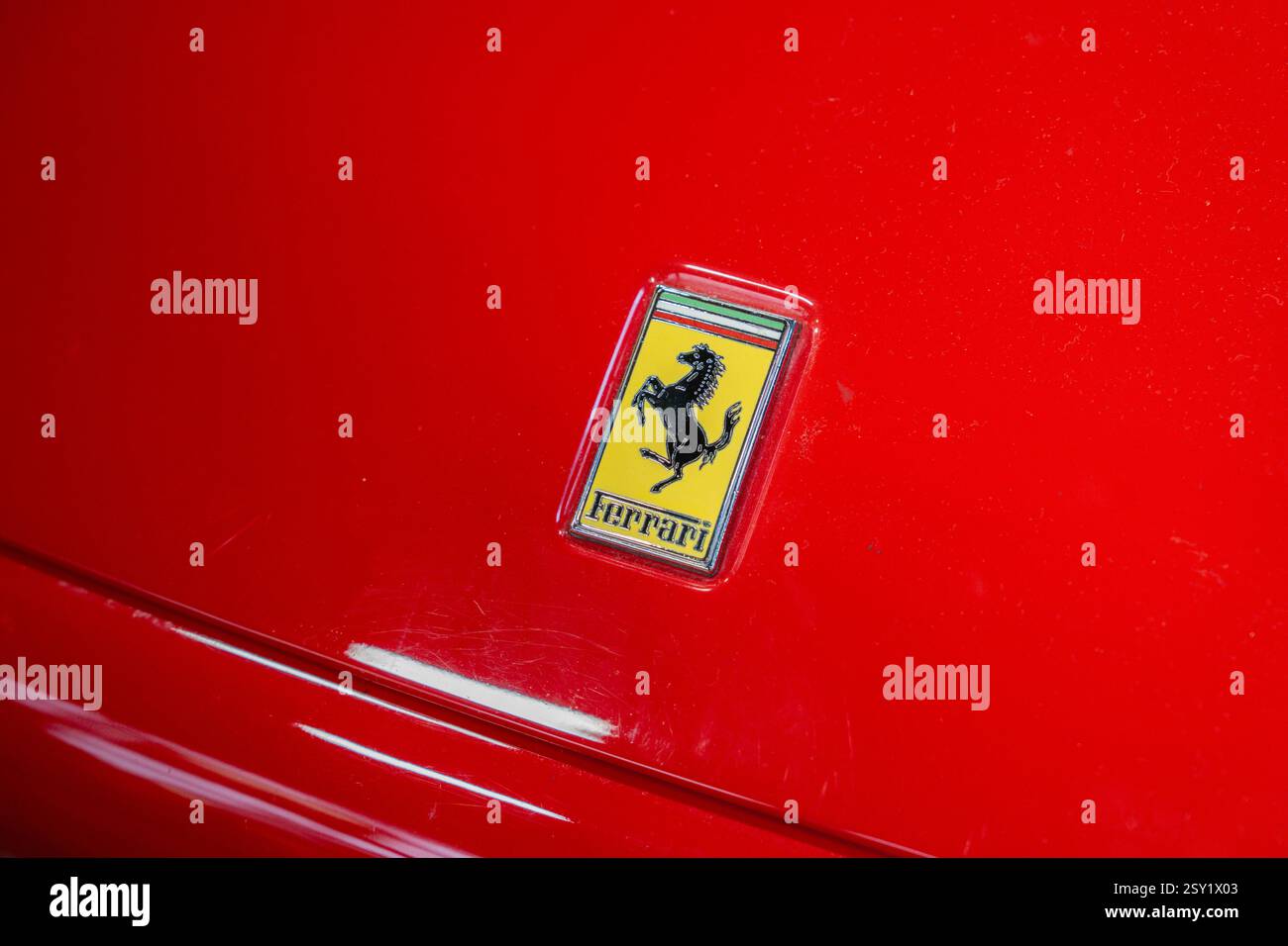 Iconic emblem of luxury and speed shines on polished red surface ...