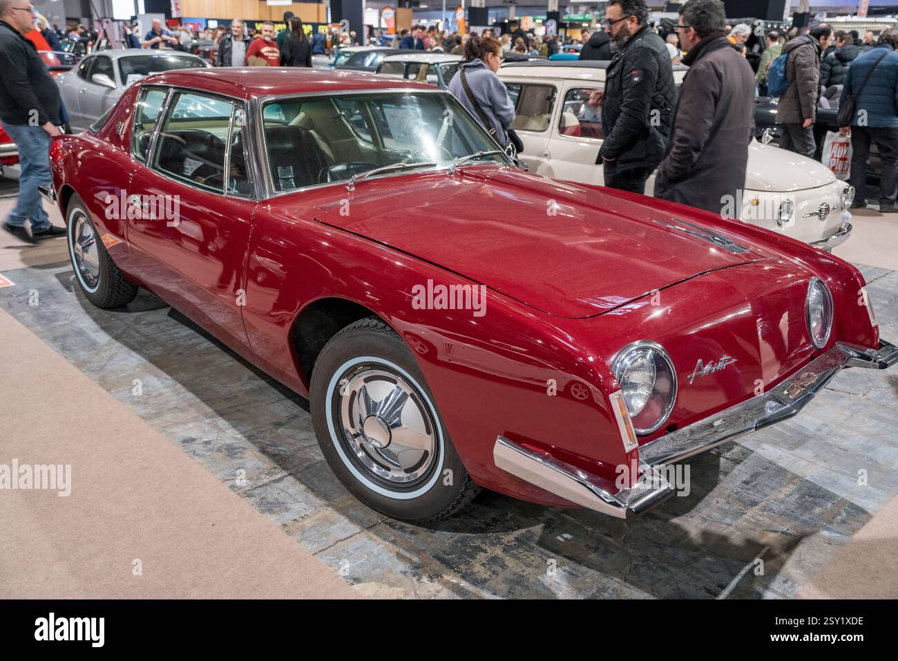 Classic crimson car stands out among vintage vehicles at auto show ...