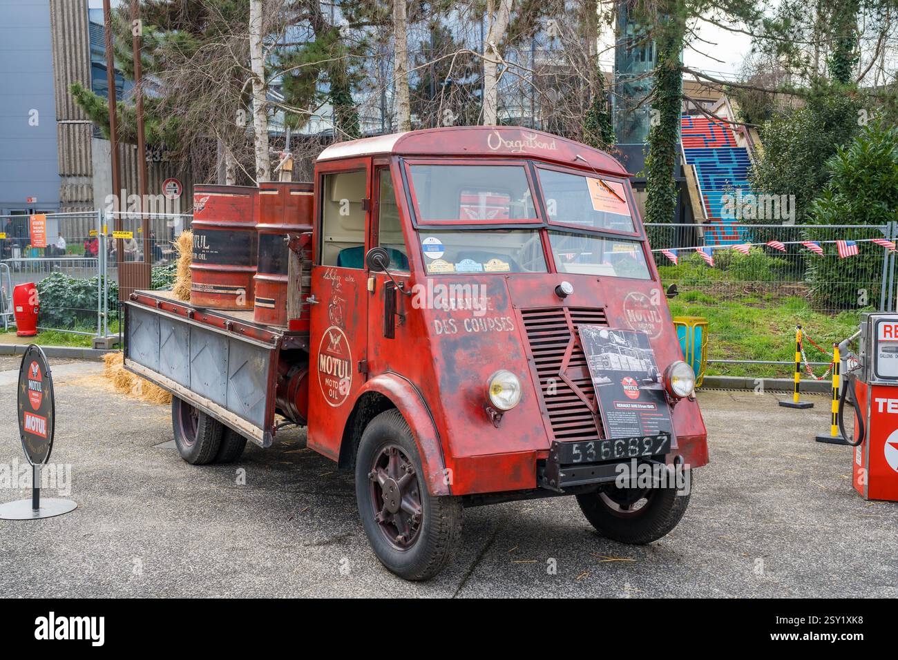 Vintage red delivery truck at a bustling outdoor event in a vibrant ...