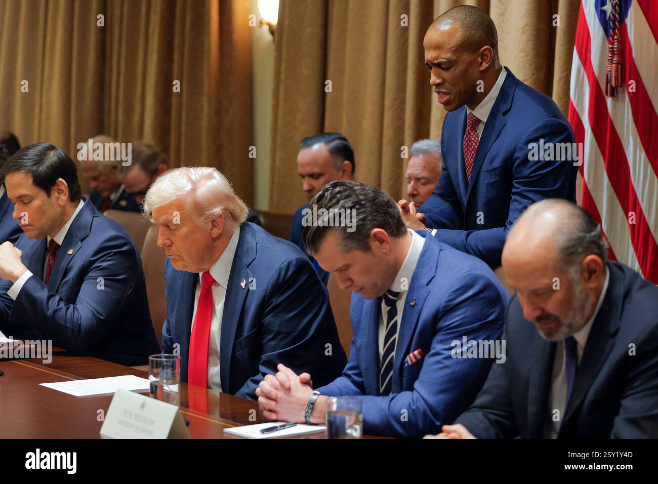 Housing and Urban Development Secretary Scott Turner prays during a ...