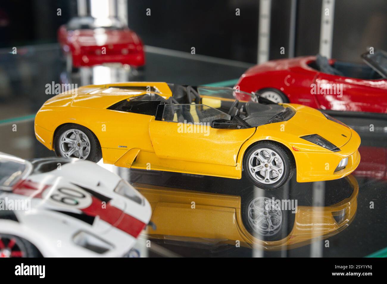 Colorful display of miniature sports cars in a showcase featuring fine ...