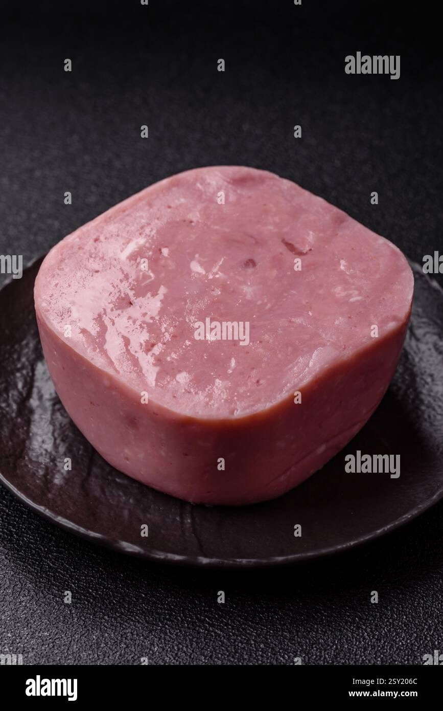 Delicious canned pink ham with salt, spices and herbs on a dark ...