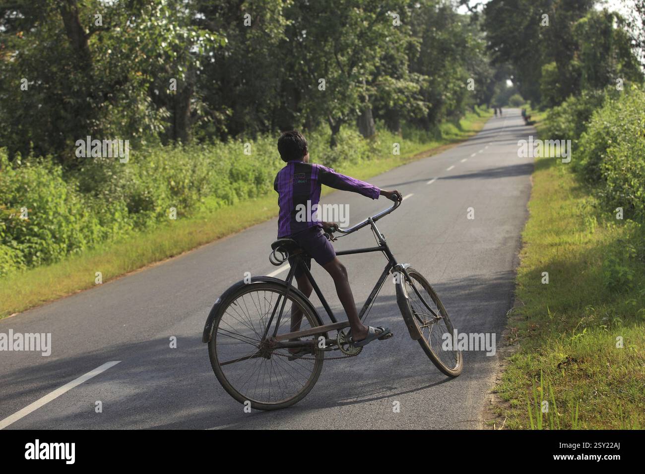 Boy riding cycle on road at Sambalpur Orissa India Stock Photo - Alamy