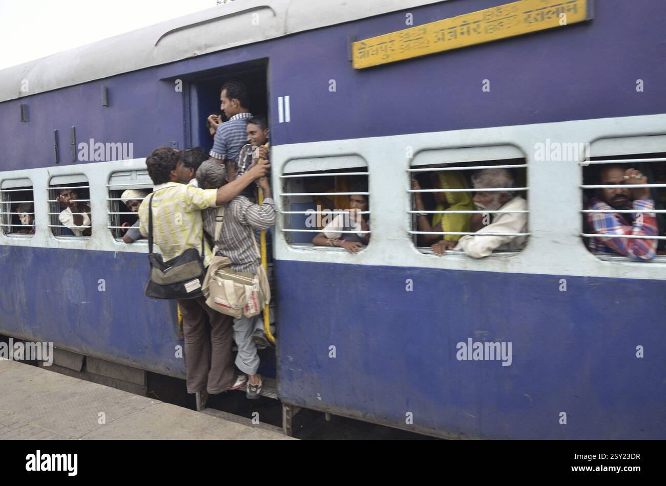 Men standing on the foot step of running train Jodhpur Rajasthan India ...