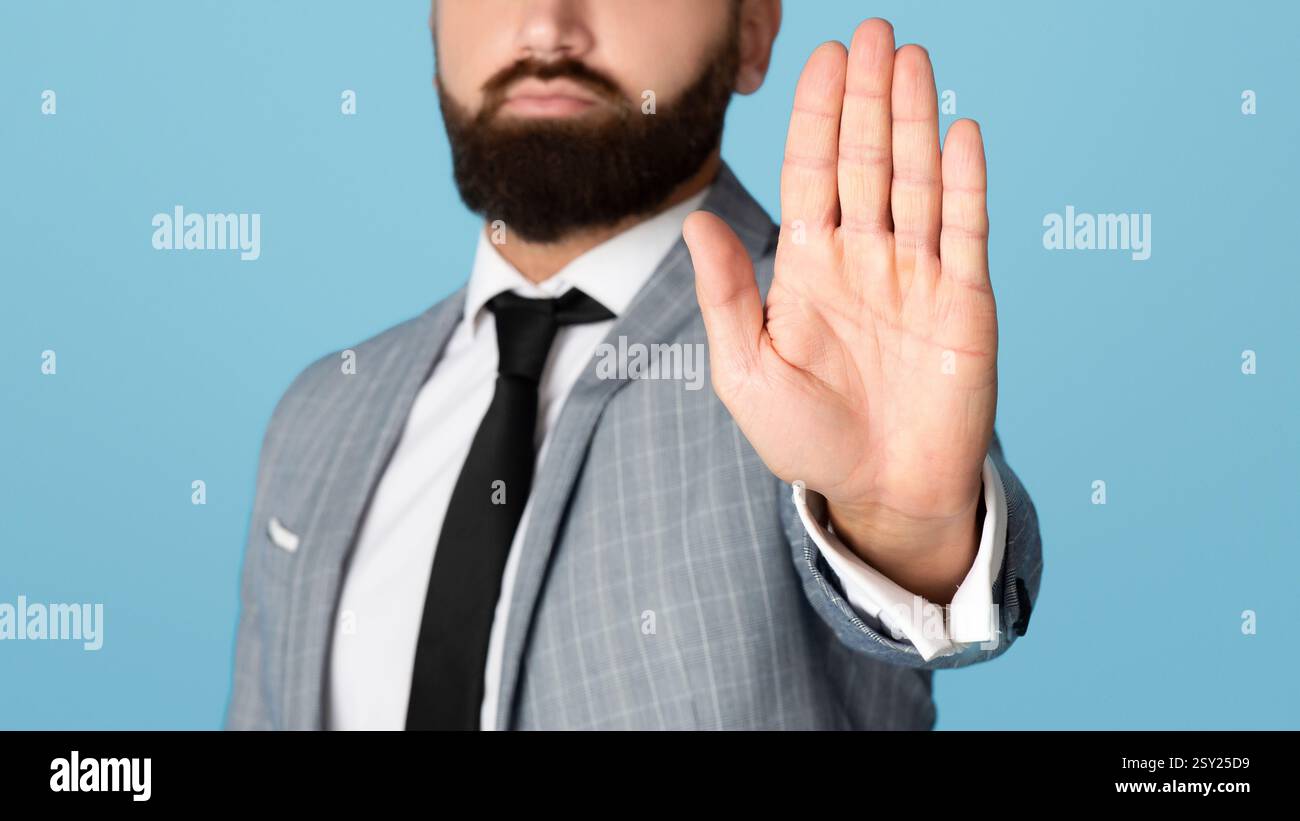Cropped view of millennial businessman refusing something, showing STOP ...