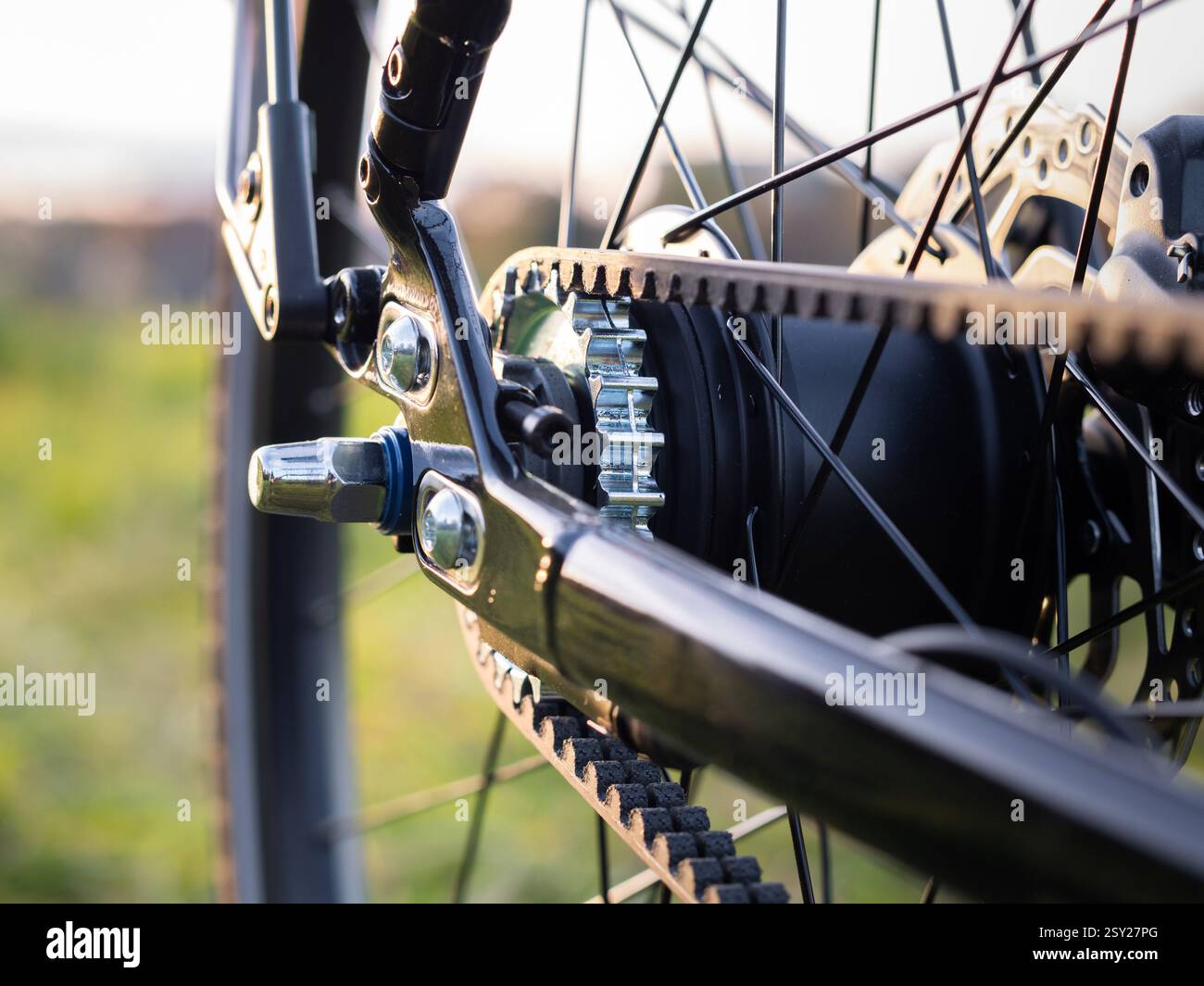 Belt drive on a bicycle. Carbon rubber belt and the sprocket at the ...