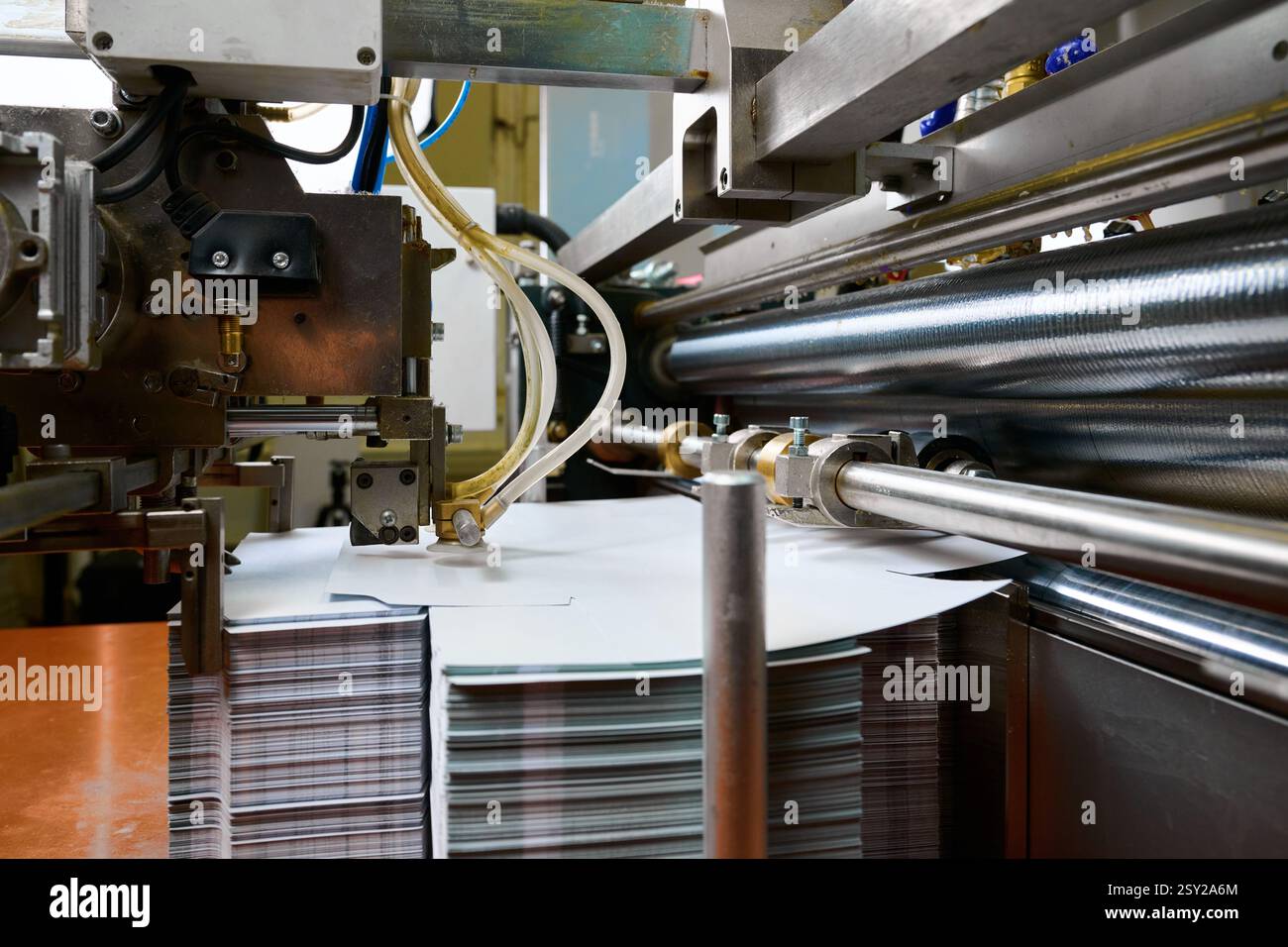 Precision adhesive application in a cutting-edge paper feed mechanism ...