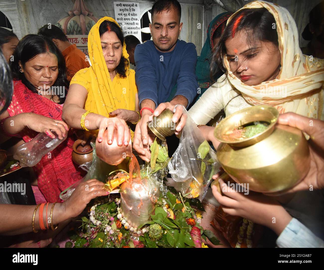 PATNA, INDIA - FEBRUARY 28: Devotees offering milk & water on Shiva ...