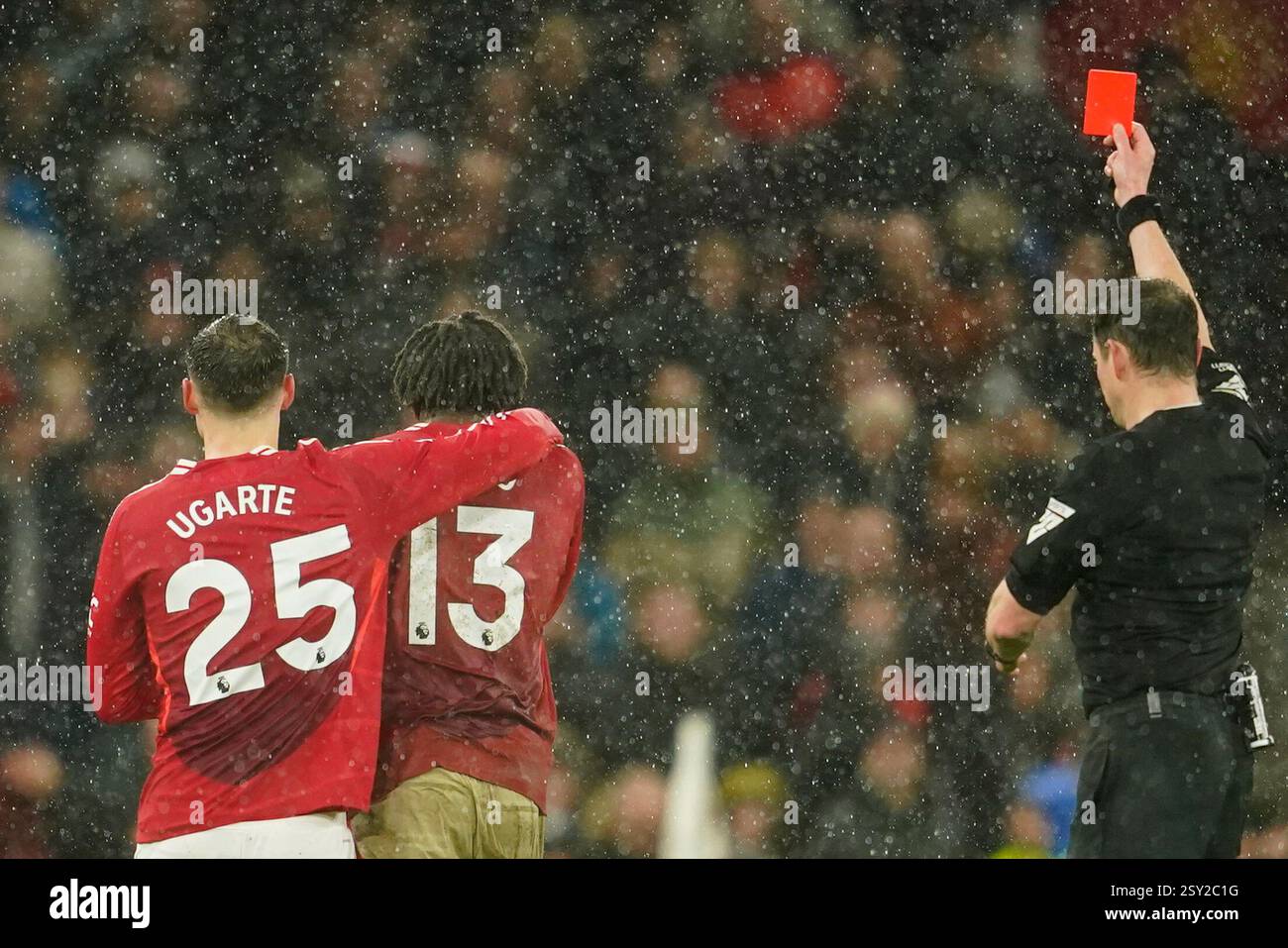 Referee Darren England shows a red card to Manchester United's Patrick ...